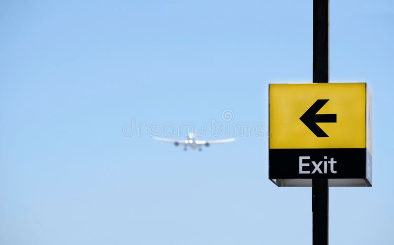 Shallow Focus of a Yellow Exit Sign with a Left Arrow Stock Photo ...