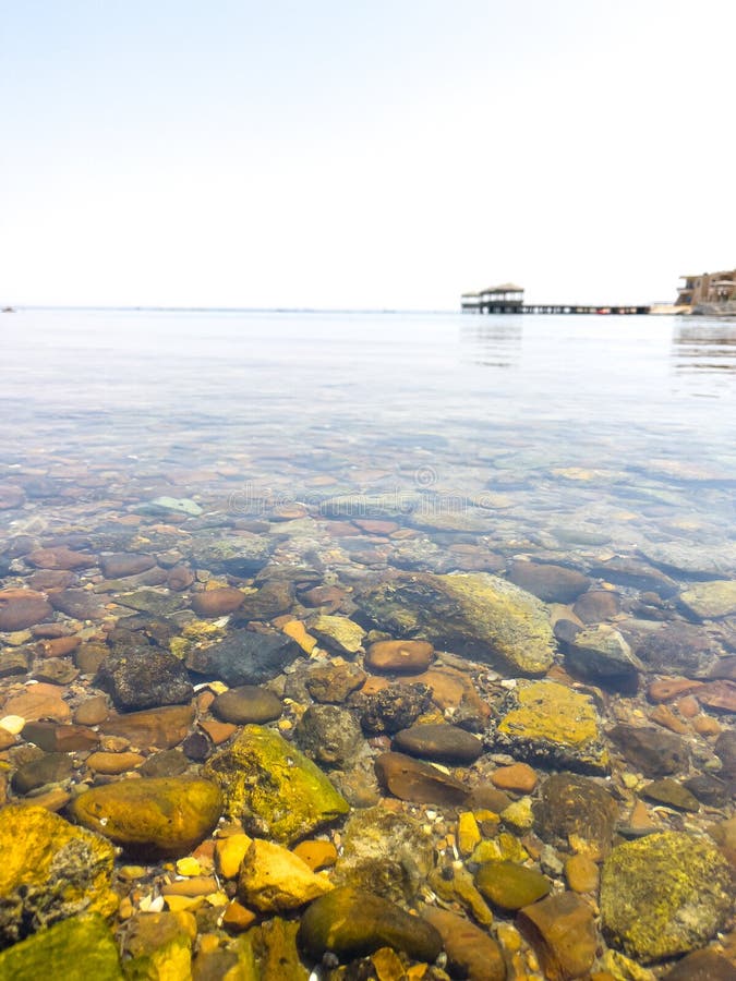 Shallow View of Bright Colors with Rocks on White Water Surface with ...