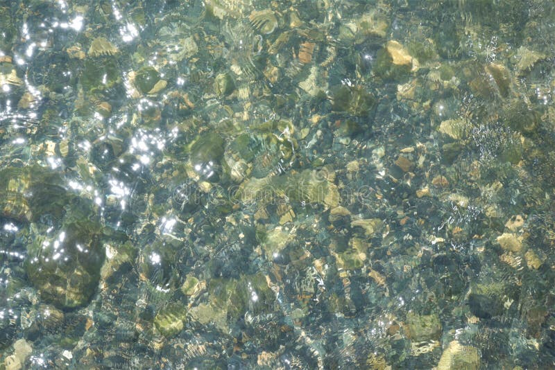 Shallow Water Texture with Visible Rocks and Sunlight Stock Image ...