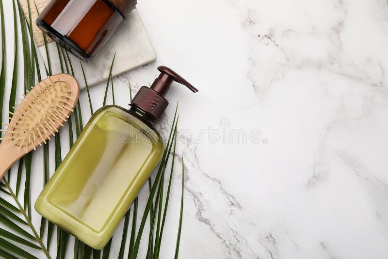 Shampoo Bottles, Hair Brush and Green Leaf on White Marble Table, Flat ...