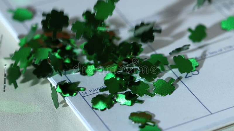 Shamrock Confetti Falling on Calander Stock Video - Video of covering ...