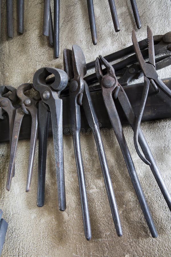 Smithy tools on the wall stock image. Image of manufacture - 132687073