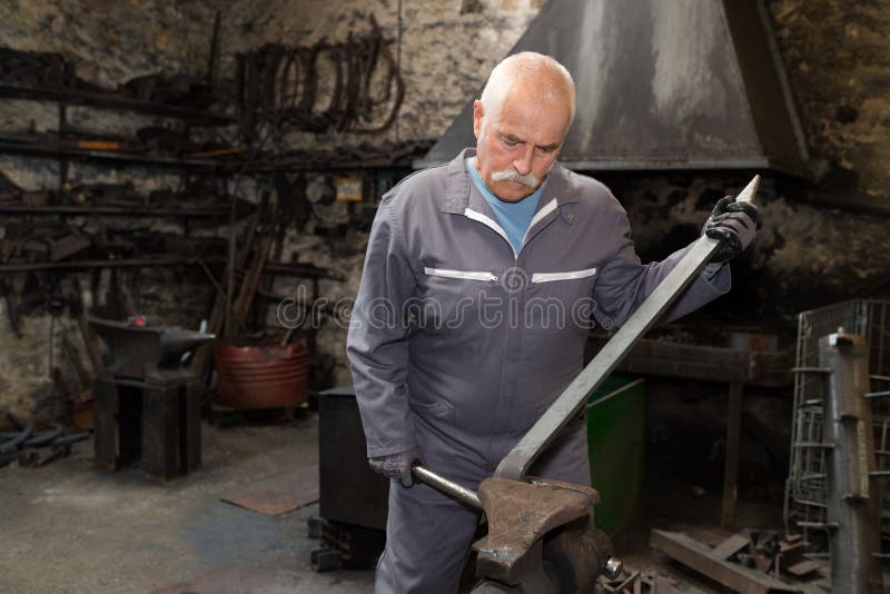 Shaping a steel rod stock photo. Image of expertise - 117893534