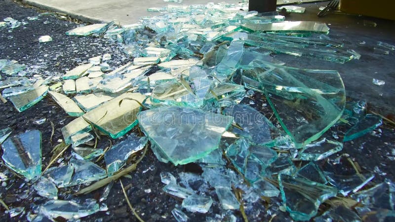 Shards of Broken Glass Scattered Across a Surface Reflecting Light in ...