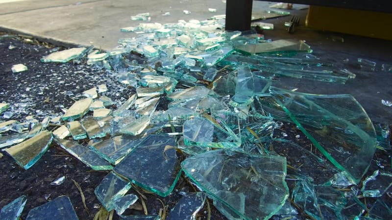 Shards of Broken Glass Scattered Across a Surface Reflecting Light in ...