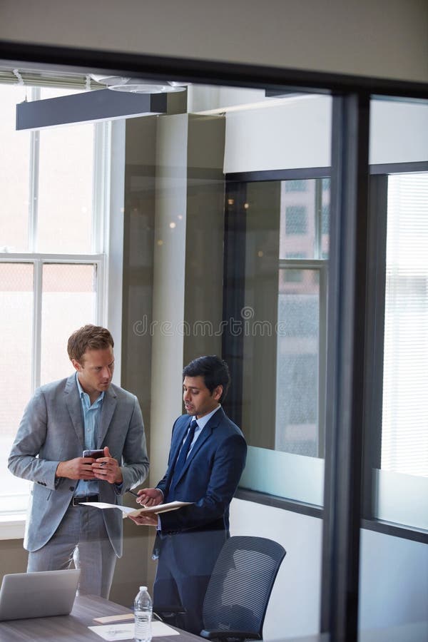 They Share the Same Vision. Businessmen Looking at Paperwork in Their ...
