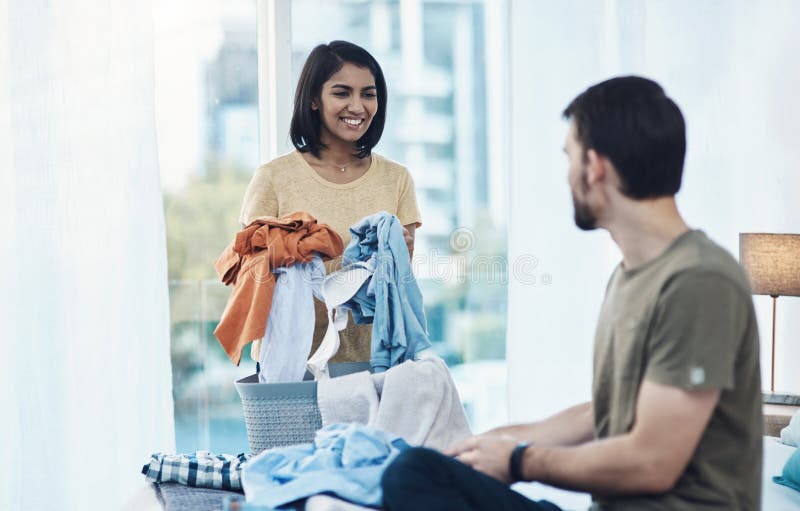 A Shared Effort Will Lighten Any Load. a Young Couple Doing Laundry ...
