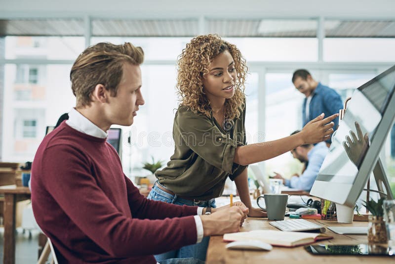 Shared Resources Bring Shared Success. Two Young Colleagues Using a ...