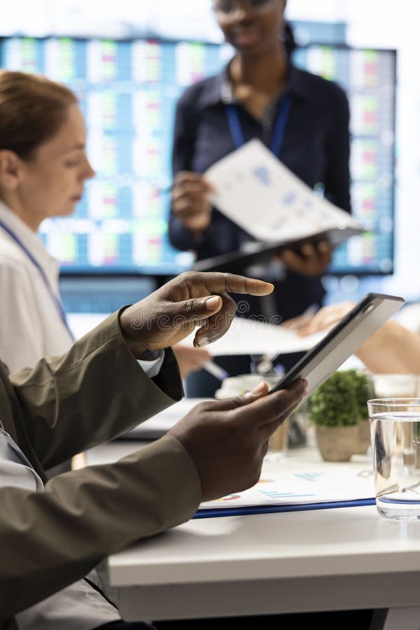 Shareholder Examining Infographics and Resource Allocation on Tablet ...