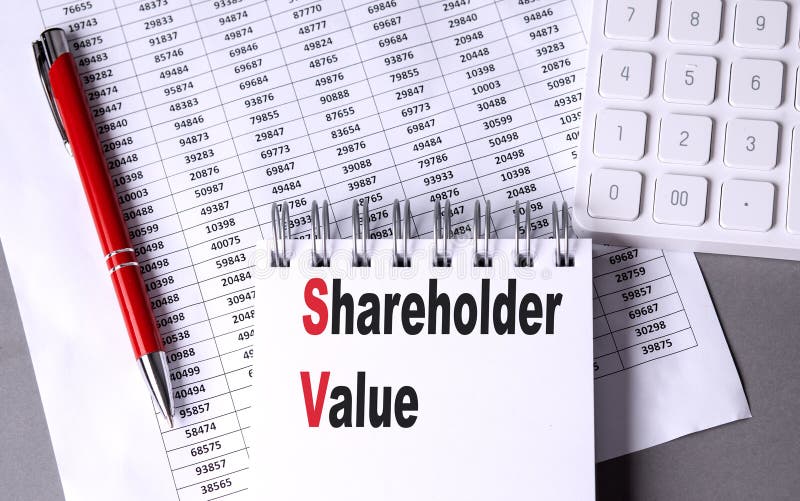 SHAREHOLDER VALUE Text on Notebook with Chart , Pen and Calculator ...