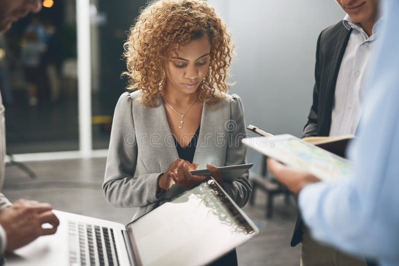 Sharing Connections. a Group of Businesspeople Using Digital Devices ...