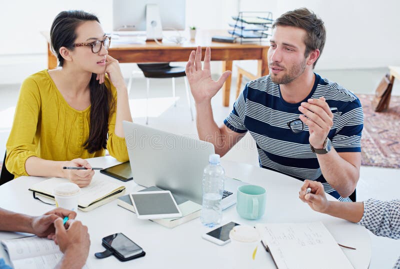 Sharing Ideas. a Group of Designers at Work in an Office. Stock Photo ...