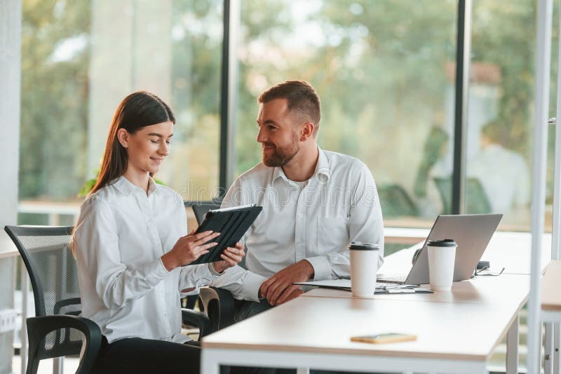 Sharing Ideas. Man and Woman are Working in the Modern Office Together ...