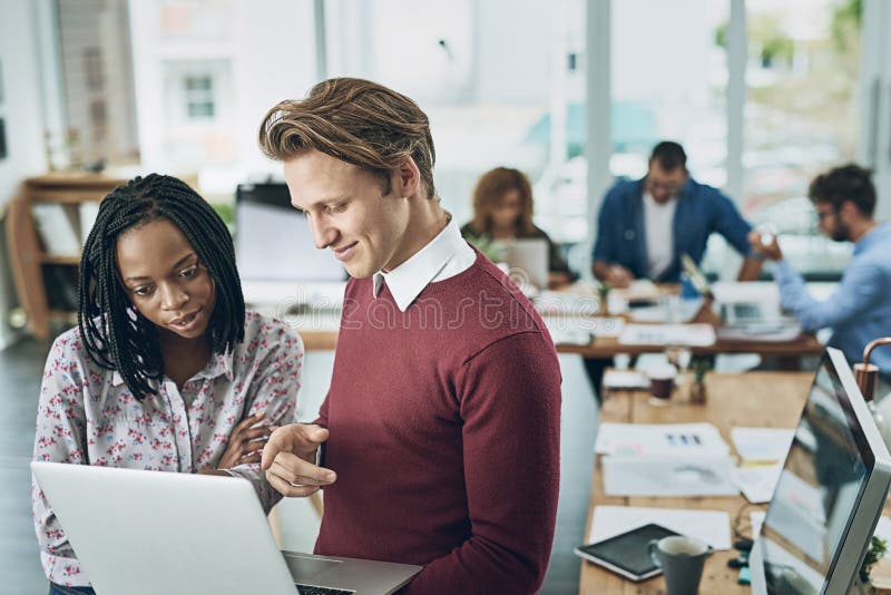 Sharing Information is a Win Win Situation. Two Young Colleagues Using ...