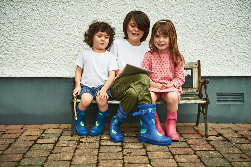 Sharing the Joys of Technology. Portrait of Three Adorable Little ...