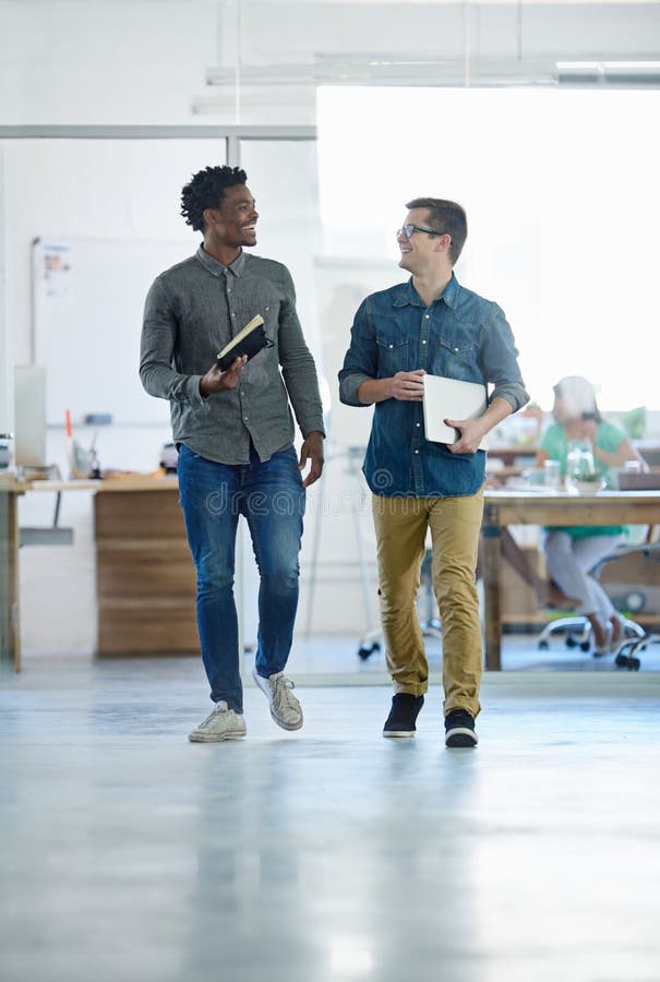 Sharing a Laugh at Work. a Two Smiling Young Coworkers Talking Together ...