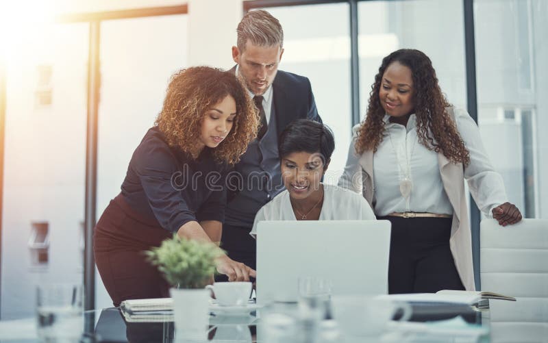 Sharing the Responsibility for a Successful Collaboration. a Group of Colleagues Using a Laptop ...