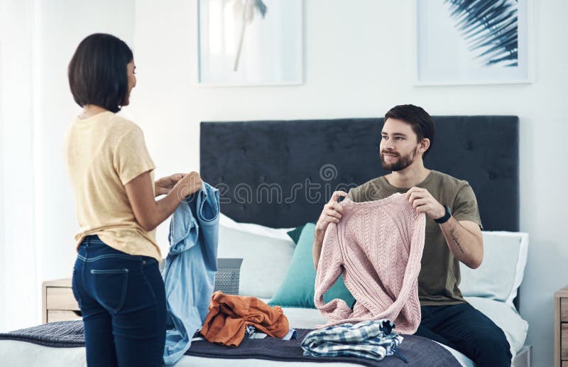 Sharing the Task Will Get it Done Fast. a Young Couple Doing Laundry ...