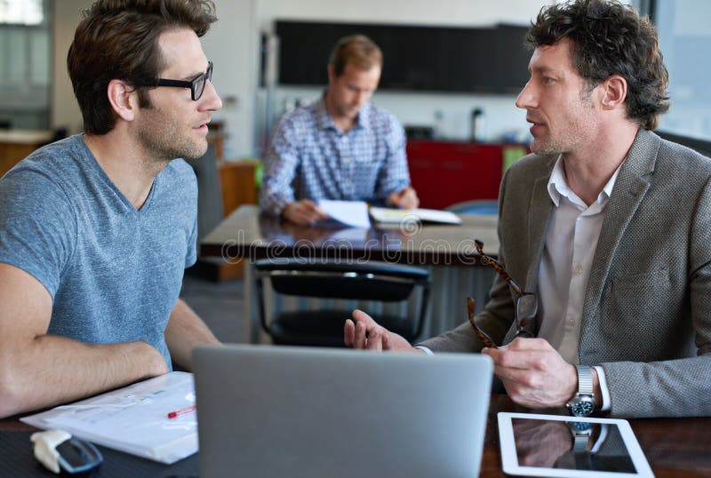 Sharing Their Ideas. Two Businessmen Going Over Some Work with Their ...
