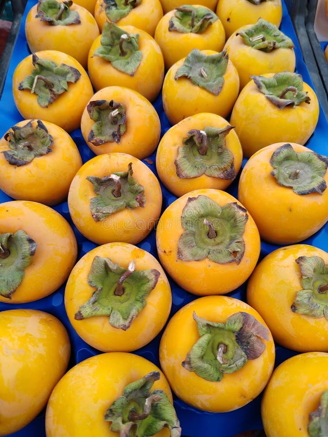 Sharon Fruit in a Tray on a Market Stall, Also Known As Persimmon Stock ...