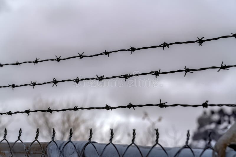 Sharp Barbed Wires of Rusty Chain Link Fence with Blurred Cloudy Sky Background Stock Image ...