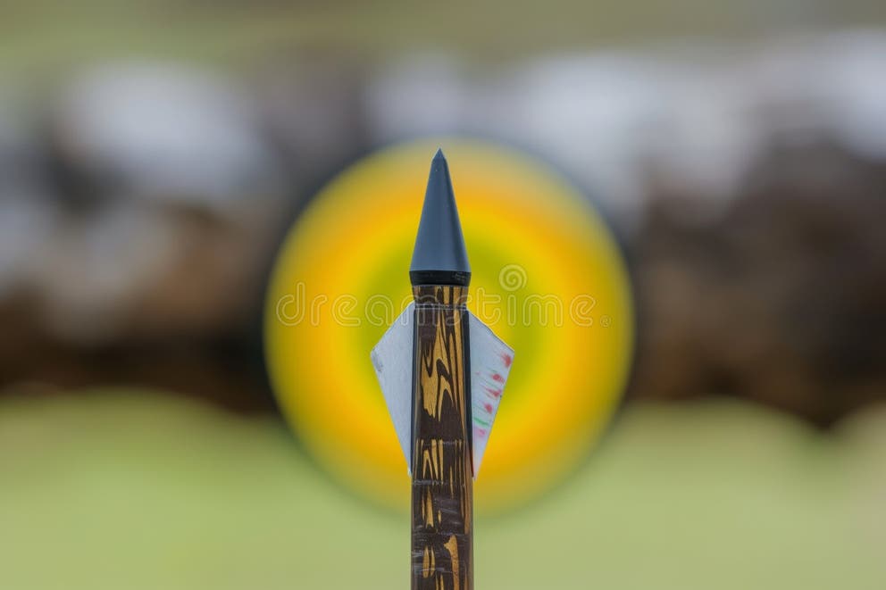 Sharp Broadhead Arrow Tip with a Blurry Yellow Target Center Stock ...
