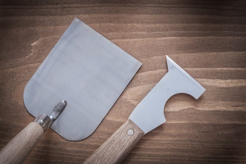 Sharp Glossy Paint Scraper and Bricklaying Trowel on Wooden Surf Stock ...