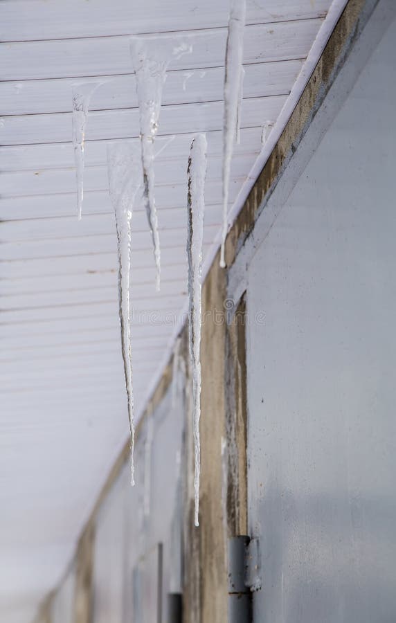 Sharp Ice Icicles Hang Under the Plastic Visor of the Roof Edge. Stock ...