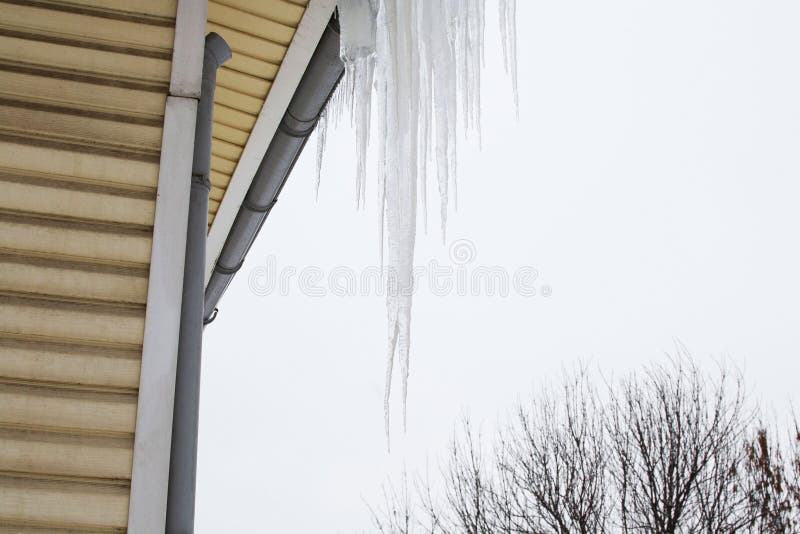 Sharp Icicles Hanging from Eaves of Roof Stock Image - Image of clear ...