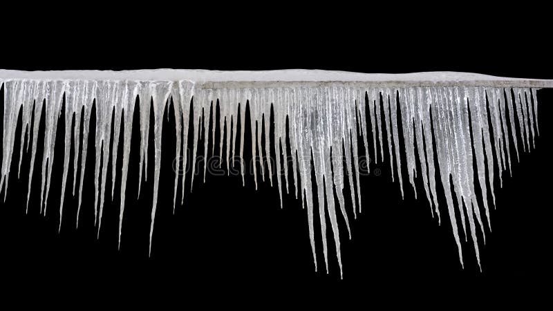 Sharp Icicles Hanging on the Edge of the Roof. Melting Snow Forms ...