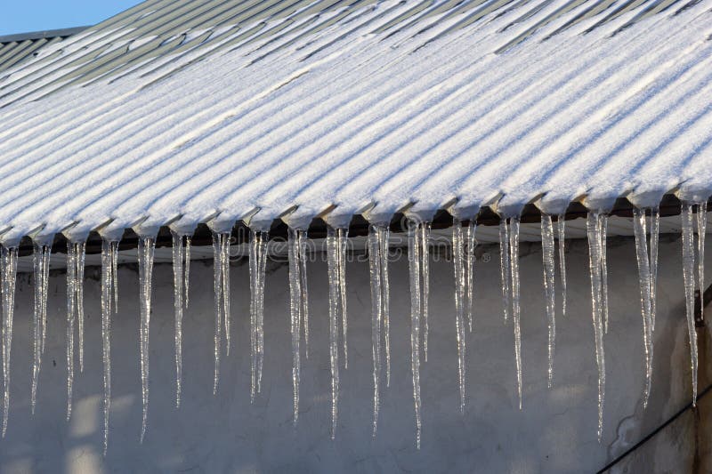 Sharp Icicles and Melted Snow Hanging from the Eaves of the Roof ...