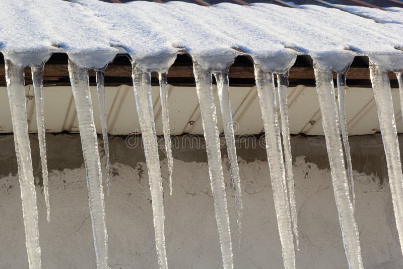 Icicles on eaves outdoors stock image. Image of melt - 194264337