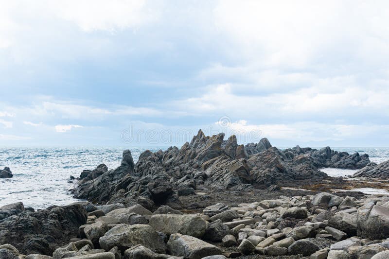 Sharp Jagged Basalt Rocks on the Sea Coast, Cape Stolbchaty on Kunashir ...