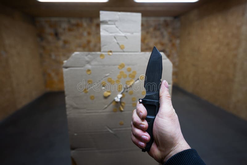 Sharp Knife in a Man S Hand and a Cardboard Target in the Shape of a ...