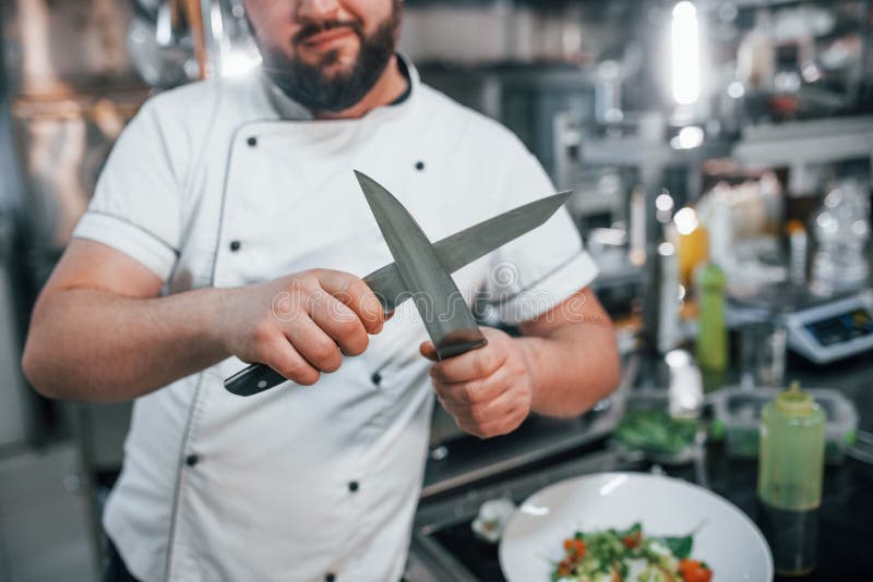 With Sharp Knives. Professional Chef Preparing Food in the Kitchen ...