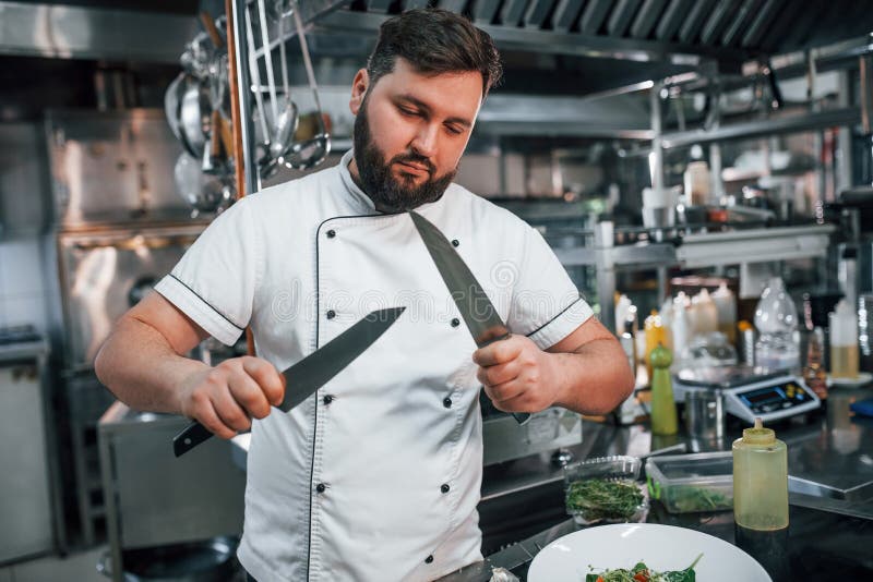 With Sharp Knives. Professional Chef Preparing Food in the Kitchen ...