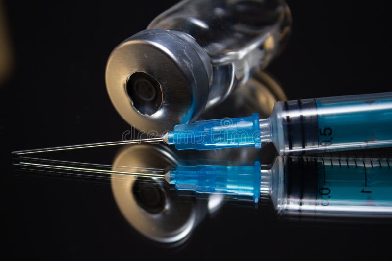 The Sharp Needle of an Open Syringe is Beautifully Reflected in the ...