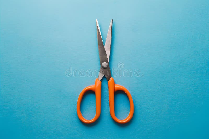 Sharp Orange Scissors Pop Against Bright Blue Background, Embodying ...