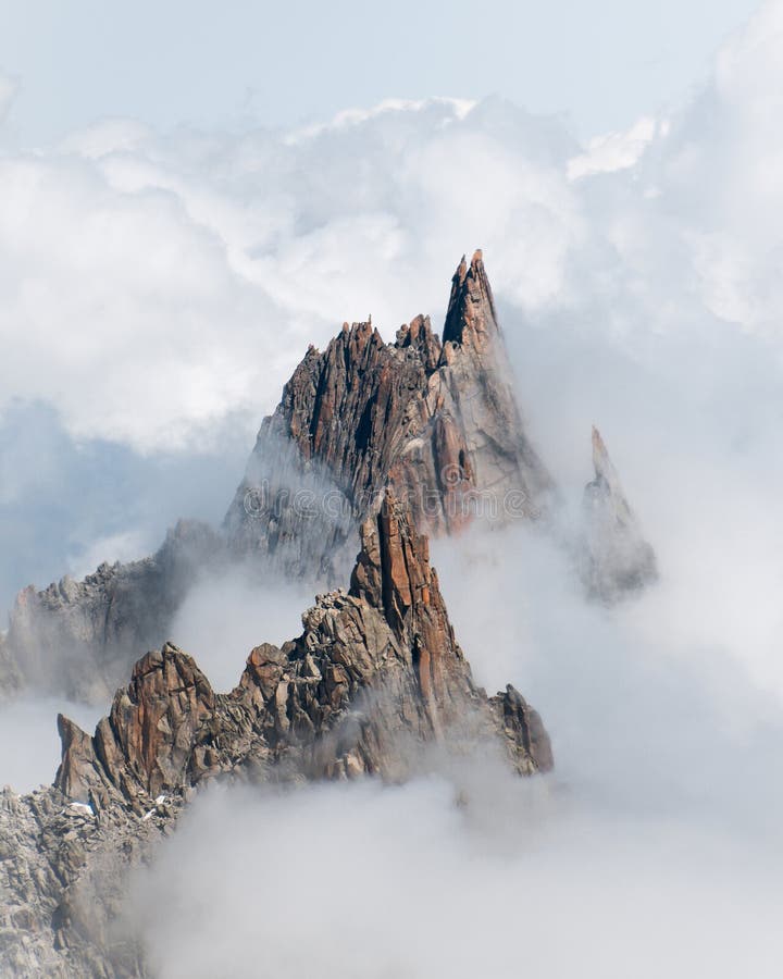 Sharp Peaks of Mont Blanc Rise Dramatically through the Clouds in Valle ...