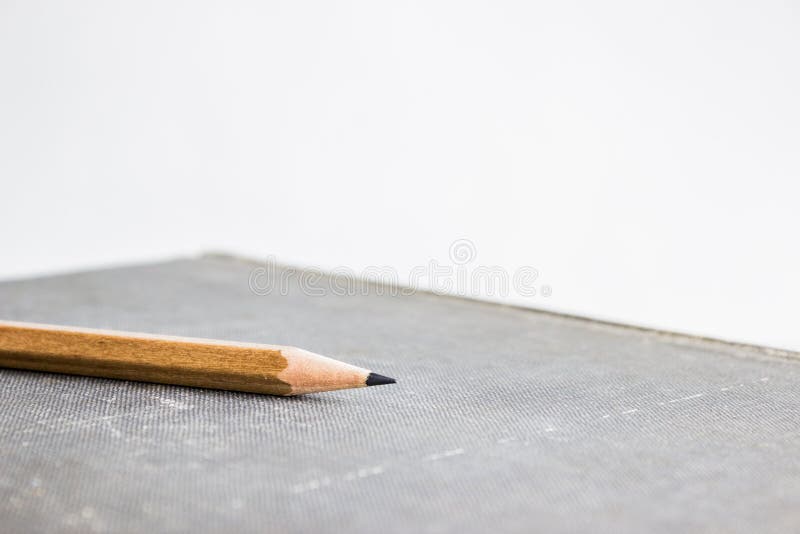 A Sharp Pencil with Book on a Wooden Table. Stock Image - Image of ...