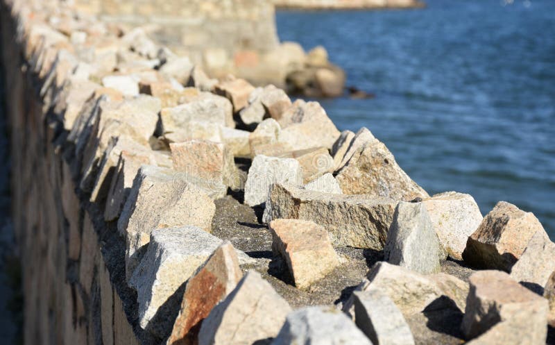 Coastal Retaining Wall with Sharp Jagged Rocks Stock Photo - Image of ...
