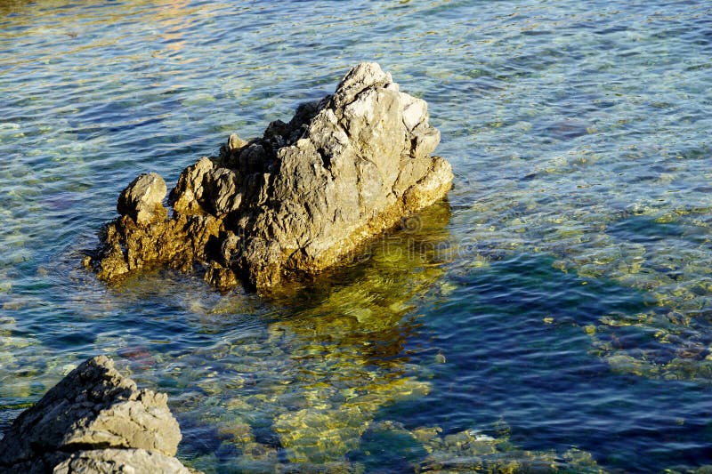 Sharp Rocks Emerging from Shallow Transparent Sea Water Stock Photo ...