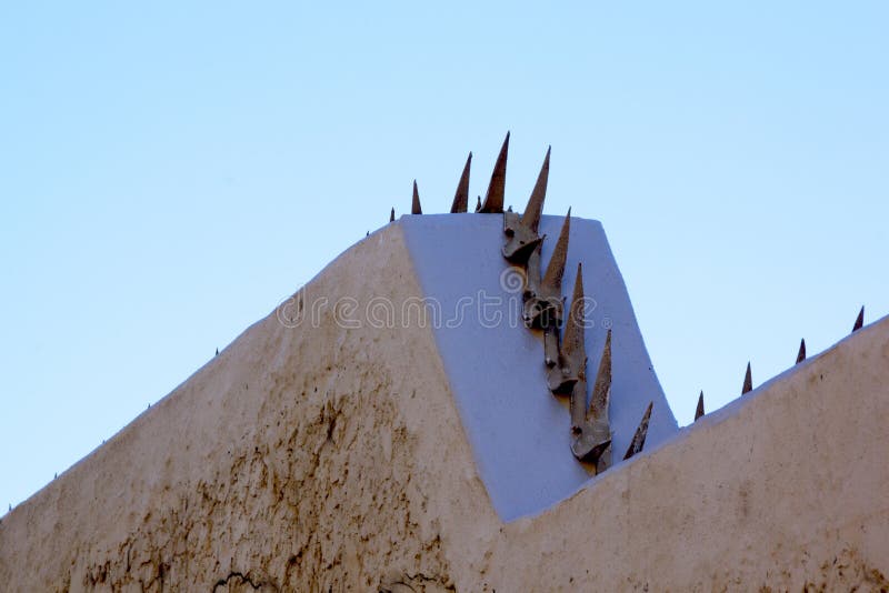 Sharp Rusty Spikes on Residential Boundary Wall Stock Photo - Image of ...