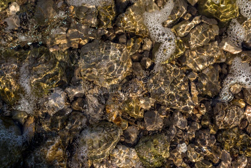 Sharp Sea Surface on the Pebbles Beach Reflecting Sun Rays.Use F Stock ...
