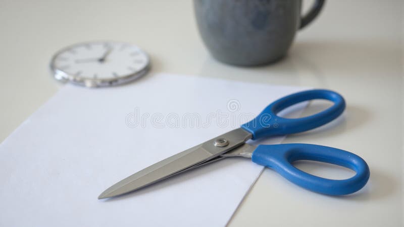 Sharp Silver Scissors with Blue Handles on a Wooden Desk Next To a ...