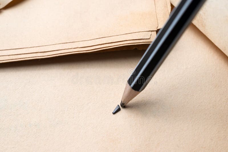 Sharpened Pencil Over a Blank Old Sheet of Paper with a Broken T Stock ...