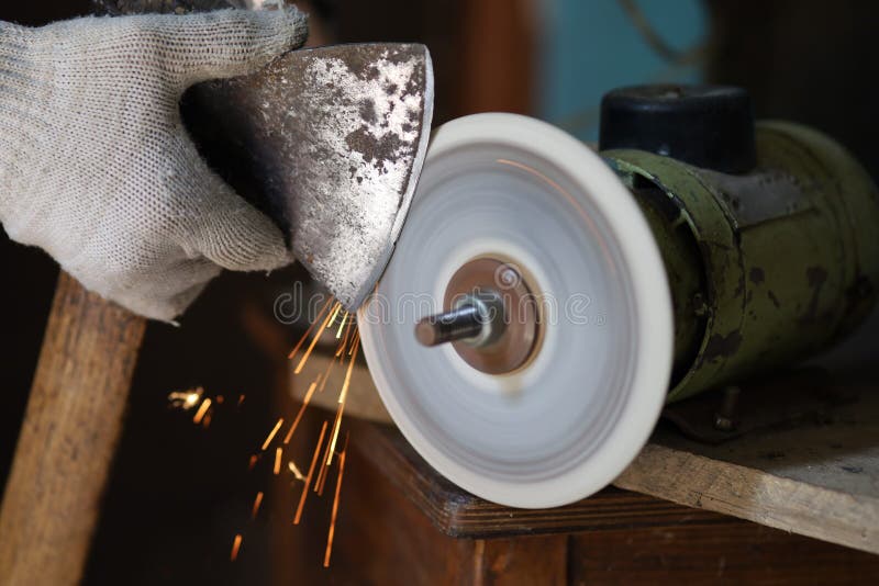 Sharpening an Ax on a Sharpener Close-up Stock Image - Image of metal ...
