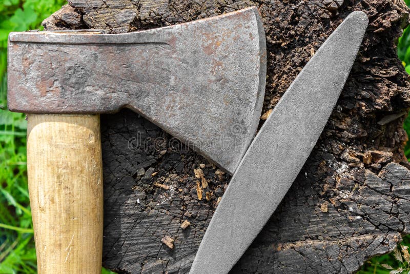 Sharpening an Ax with a Whetstone. Ax and Grindstone on a Stump Stock ...