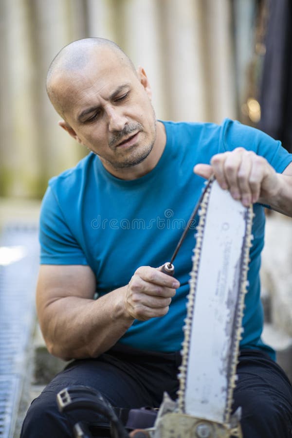Sharpening a chainsaw stock photo. Image of grind, file - 162269734