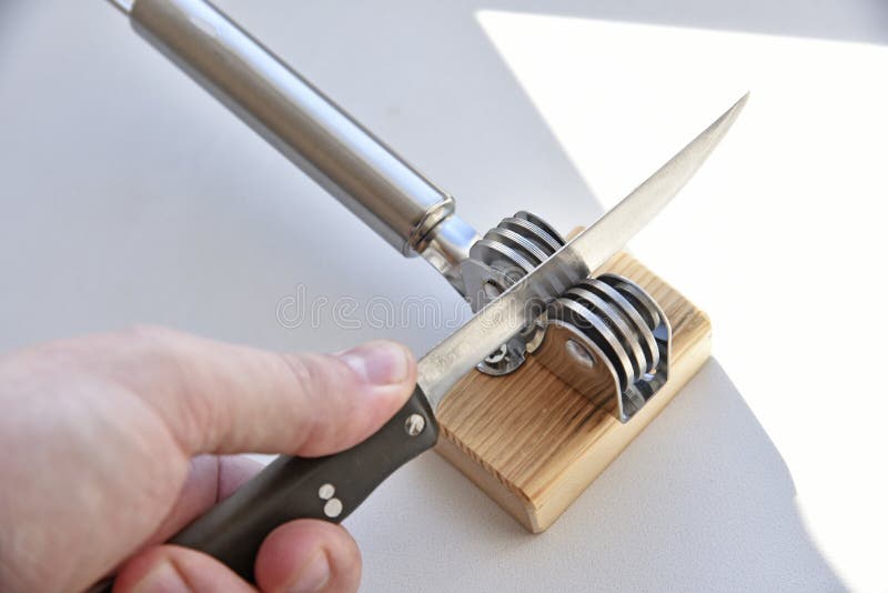 Sharpening an Iron Knife with a Sharpener Stock Photo - Image of ...